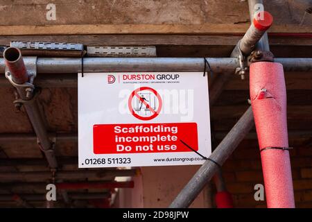 Warning sign at scaffolding warning that it is incomplete and do not ...