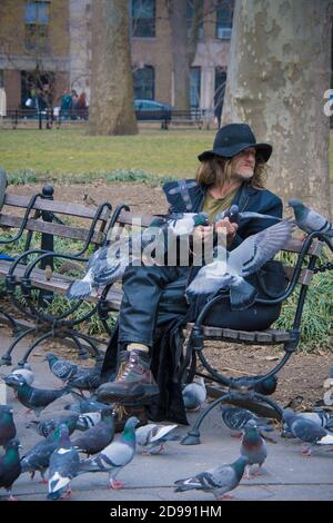 Larry Reddick, known as Larry the Birdman, feeding a flock of pigeons ...