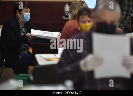 Employees sort vote-by-mail ballots from municipal elections on ...