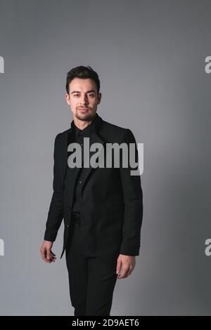 dramatic portrait of millennial in black knitted hat and sweater on ...
