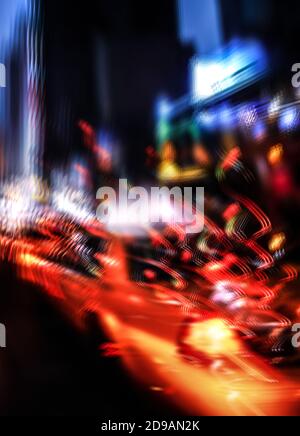 An illuminated NYC street at night, with multiple street lights casting ...
