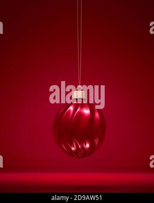 A glossy red bauble with the golden shape of a gift.(series Stock Photo ...