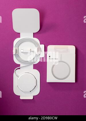 Smartphone charging on a purple background. Mobile phone with connected ...