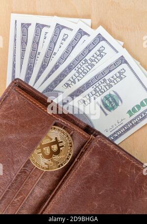 Gold bitcoin with dollars in brown leather wallet. Virtual ...