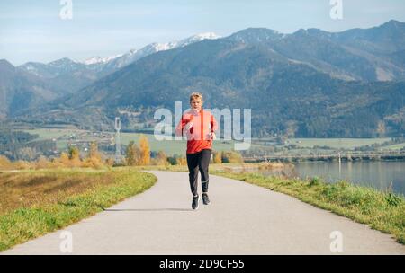sporty young man with black trousers, grey t-shirt with black electric ...