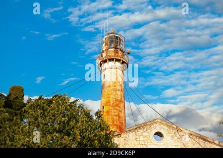 Old abandoned steel rusty lighthouse on the beach on the Dzharylgach ...