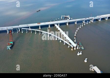 An aerial view of workers building the Zhoudai Bridge, which connect ...