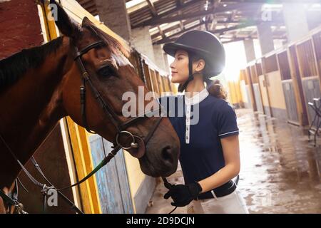 Barns in young women and horses Stock Photo - Alamy