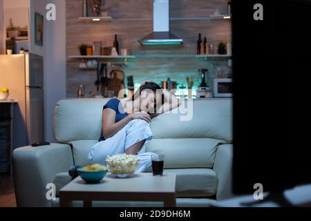 Young woman falling asleep while watching television Stock Photo - Alamy
