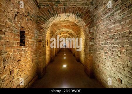 Brick tunnel archway made of red bricks as a passage between the two ...