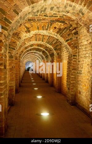 Brick tunnel archway made of red bricks as a passage between the two ...