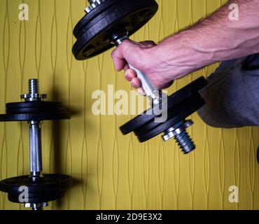 Closeup shot of a dumbbell in hand Stock Photo - Alamy