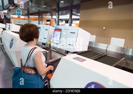 Passenger using convenient self check-in luggage bag machine at KL ...
