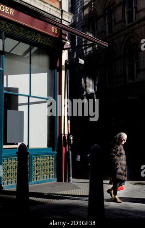 A woman walks in the sun in London, Tuesday, June 23, 2026, as a heat ...