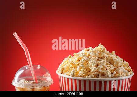 Tasty popcorn and cola on color background Stock Photo - Alamy