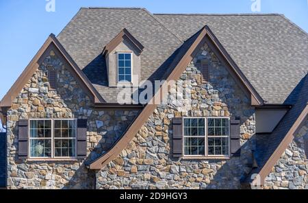 Double gable with dark stone veneer siding, with triangle shape peaks ...