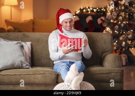 Young student with book at Christmas eve Stock Photo - Alamy