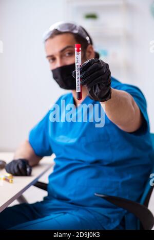 Male biochemist testing blood samples Stock Photo - Alamy