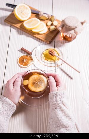 Women's hands hold a white Cup of cappuccino or cocoa. The view from ...