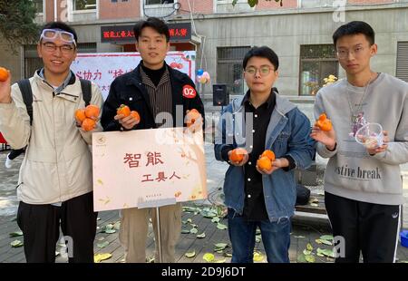 Students show their persimmon picked in the Northwestern Polytechnical ...