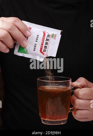 In this unlocated photo, a person pours a bag of Isatis Root, also ...