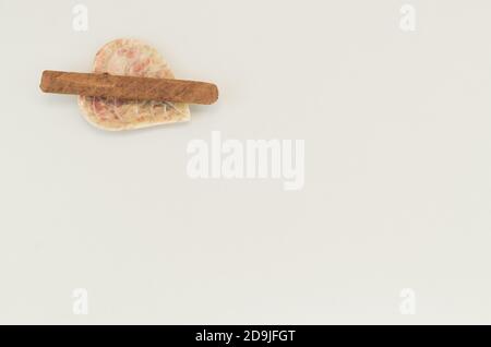 Top view of cigar on a heart-shaped tray with copy space isolated on ...