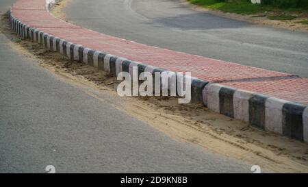 Road divider in a countryside road in India. road with traffic lane ...