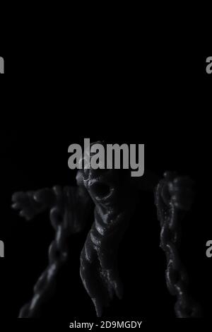 chained ghost in the darkness with a black background Stock Photo - Alamy