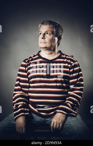Solid middle aged man studio portrait on grey background Stock Photo ...