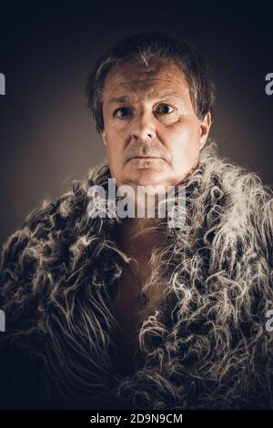 Solid middle-aged man in a fur mantle studio portrait Stock Photo - Alamy