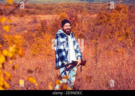 Poacher with Rifle Spotting Some Deers. Hunter with shotgun gun on hunt ...