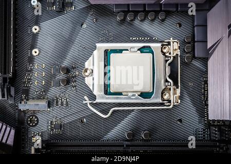 Closeup detail of CPU Chip over socket of a modern computer black ...