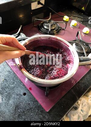 Sweet homemade blackberry jam in small glass jar on a white background ...