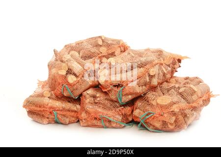 Firewood in the net bag isolated on white background Stock Photo - Alamy