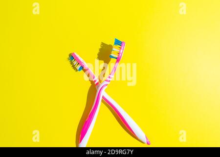holding a toothbrush. old and new toothbrushes are located side by side ...