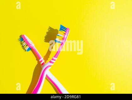 holding a toothbrush. old and new toothbrushes are located side by side ...