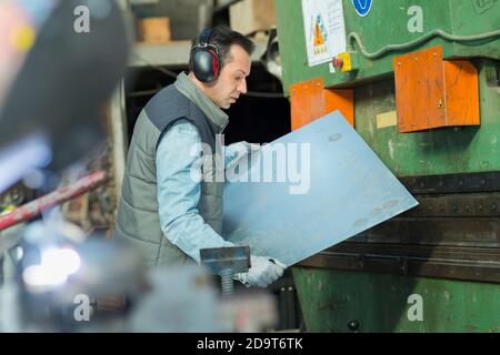 man controlling hydraulic press machine for cutting steel Stock Photo ...