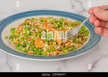 Blend of couscous, orzo, garbanzo beans, red quinoa cooked with shrimps ...