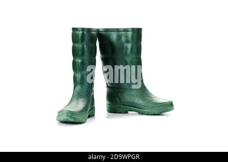 Waterproof rubber boots leather safety gloves on metallic background ...