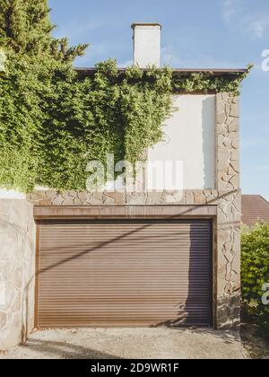 modern closed garage with metal door on street of city at night time ...