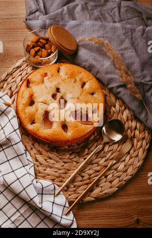 Pear tart on brown wooden rustic table, top view. Copy space, space for ...