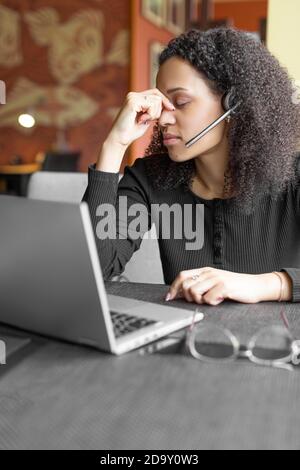 Tired business woman takes off glasses, feeling tired eyes from working ...