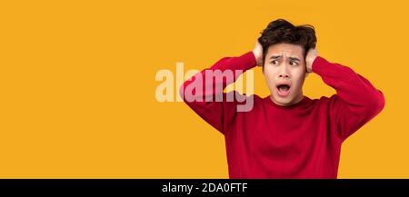 Surprised asian guy seeing shocking advertisement, panorama Stock Photo ...