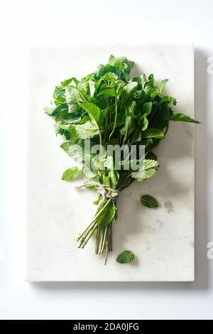 Fresh mint on Cutting board table, top view. Flat lay Space for text ...