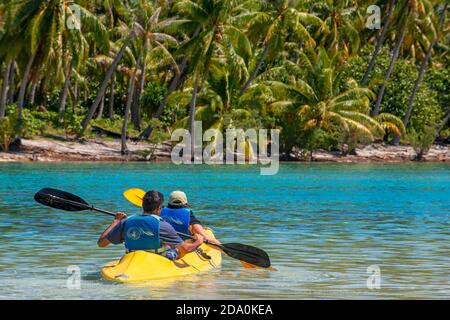 Kayaking in Taha'a island beach, French Polynesia. Motu Mahana palm ...