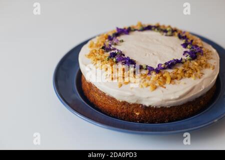 Appetizing rustic homemade cake topped with white cream and decorated ...