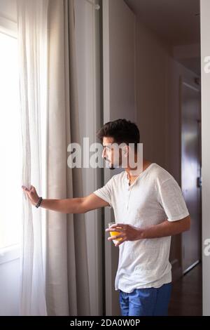 Morning routine. Awake man drink coffee using laptop. Morning in bed ...