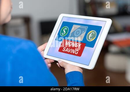 Tablet screen displaying a money saving concept Stock Photo - Alamy
