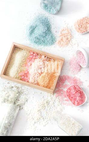Multicolored sea salt in a box on a white background top view, flat lay ...