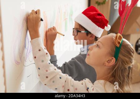 happy children drawing on christmas at home Stock Photo - Alamy